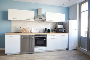 Apartamento Deluxe, 1 cama queen-size, cozinha, Vista para a cidade | Cozinha privada | Um frigorífico/congelador grande, um micro-ondas, um forno