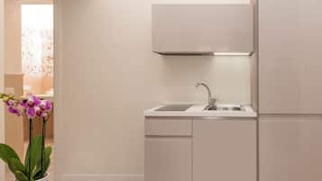 Um frigorífico, uma cafeteira/bule, uma chaleira elétrica