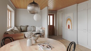 Uma sala de estar moderna com teto de madeira, uma mesa de jantar redonda e um sofá com almofadas.