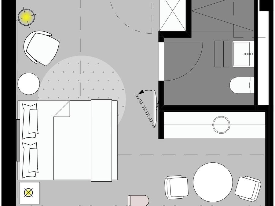 Planta de um quarto de hotel, com um espaço central amplo, um banheiro pequeno e uma área de jantar.