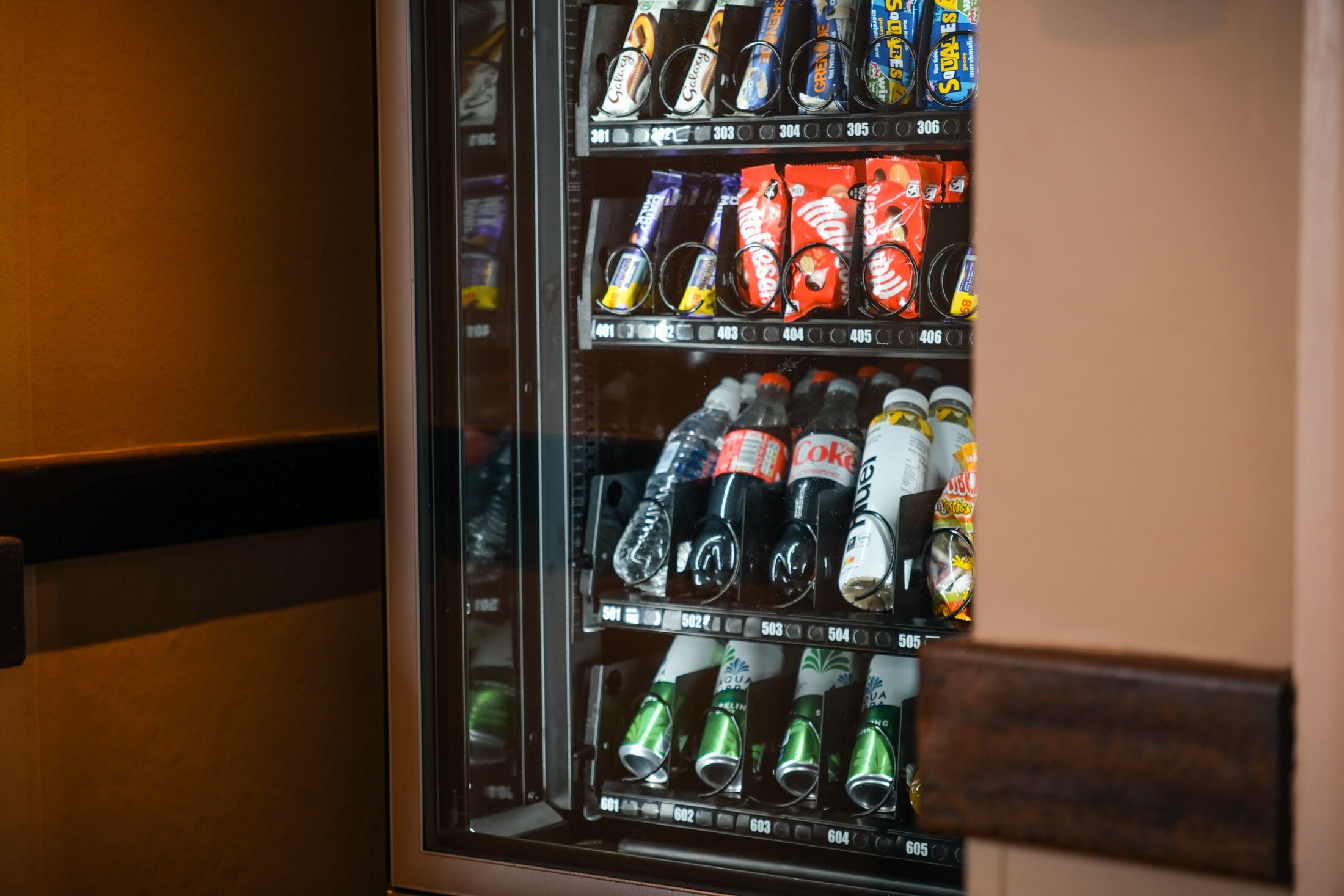 Máquina de vendas com diversos petiscos e bebidas.