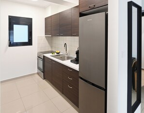 Apartamento Deluxe | Cozinha privada | Um frigorífico, um forno, uma placa de cozinha, utensílios de cozinha 