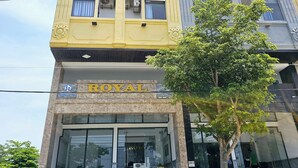 Um hotel de vários andares com uma placa grande 'ROYAL' na fachada.