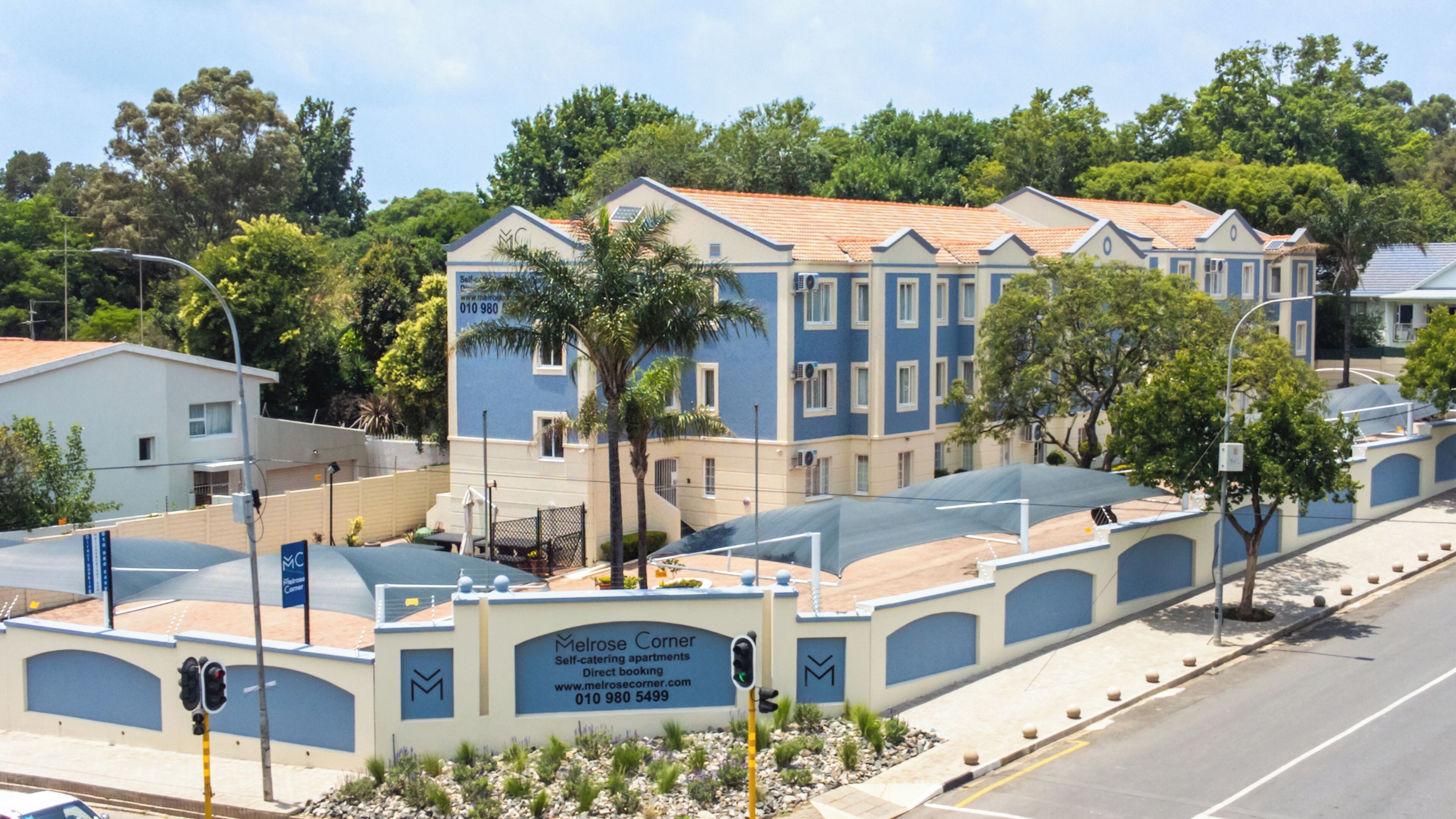Um complexo de apartamentos para aluguel por temporada com placa indicando disponibilidade para reserva direta.