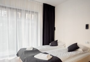 Apartamento família, 2 quartos, no piso térreo | Cortinas blackout, ferros/tábuas de passar roupa, Wi-Fi de cortesia