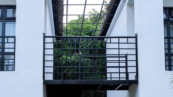 Um edifício branco com uma escadaria que leva a uma varanda.