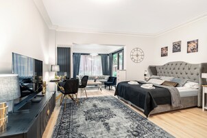 Um quarto moderno com uma cama grande, uma escrivaninha e um sofá.