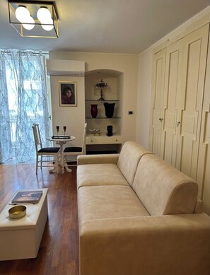 Quarto quádruplo luxo, sacada, vista para a cidade | Área de estar | TV