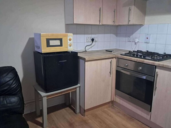 Um frigorífico, um micro-ondas, um forno, uma placa de cozinha