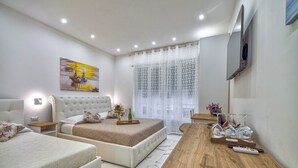 Um quarto moderno com uma cama, uma escrivaninha de madeira e uma televisão.
