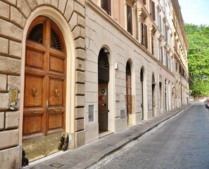 Um edifício histórico com grandes portas de madeira e janelas em arco.