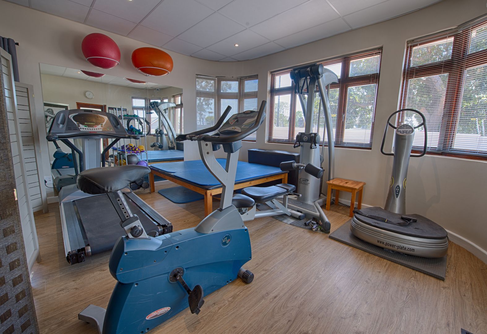 Uma academia com diversos equipamentos de exercício, incluindo esteiras, elípticos e bicicletas ergométricas.