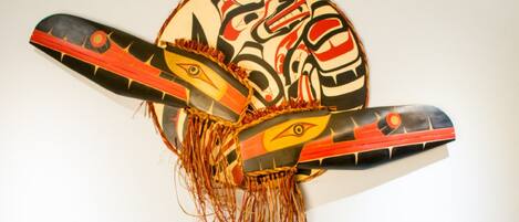 Pedaço decorativo fixado na parede com arte indígena.