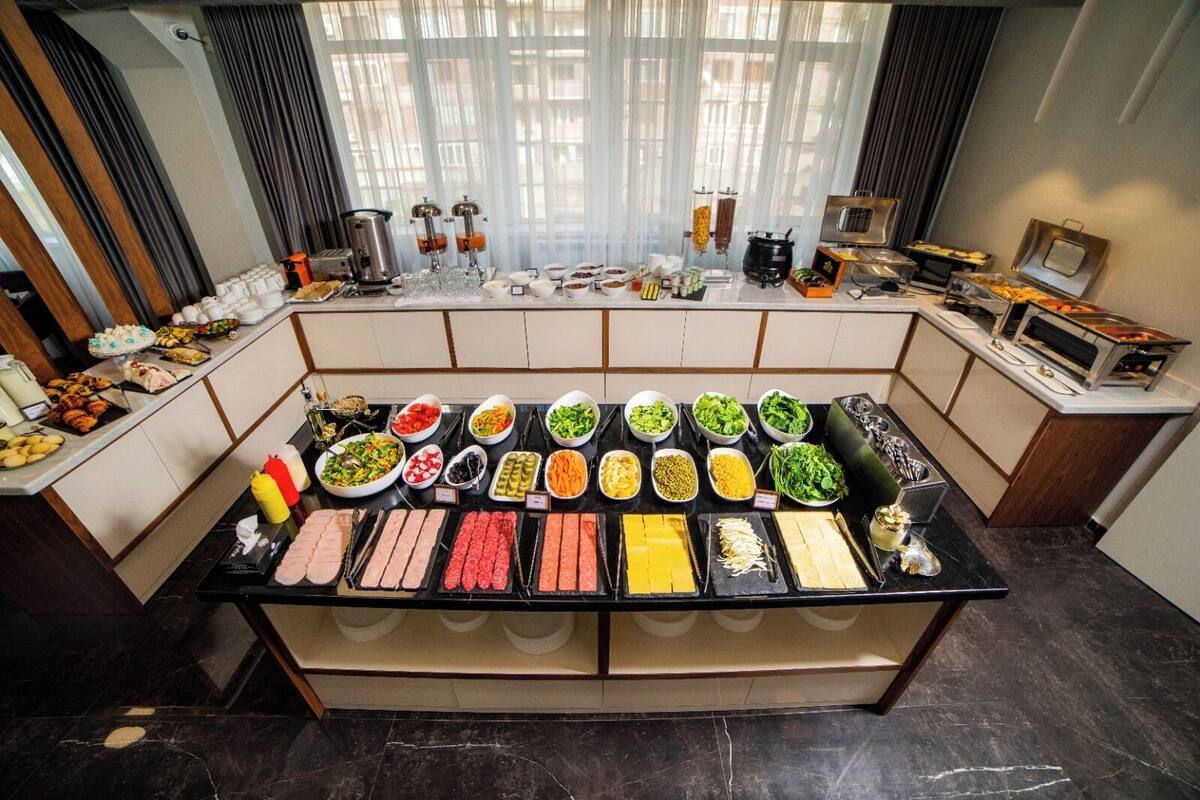 Buffet com diversas opções de comida e um espaço para café.