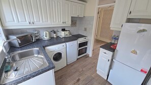 Um frigorífico, um micro-ondas, um forno, uma placa de cozinha