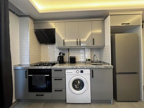 Geladeira grande, fogão, cooktop, talheres/pratos/utensílios de cozinha