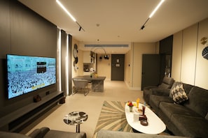 Suite Deluxe, várias camas | Sala de estar
