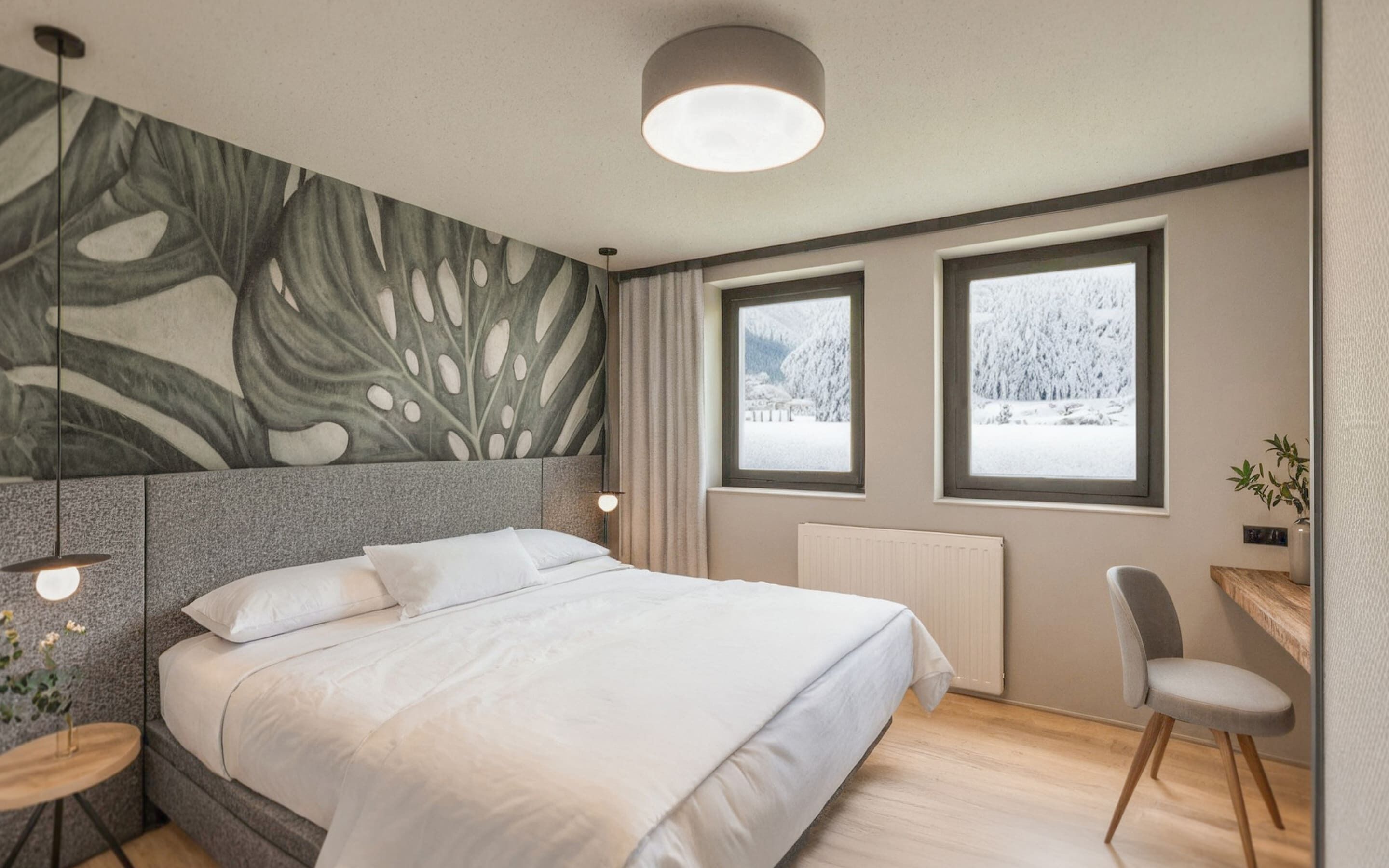Quarto moderno com uma cama grande, duas janelas com vista para a neve, uma escrivaninha com cadeira e uma luminária fixada na parede.