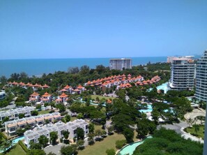 Resort com vários edifícios, piscina e vista para o oceano.