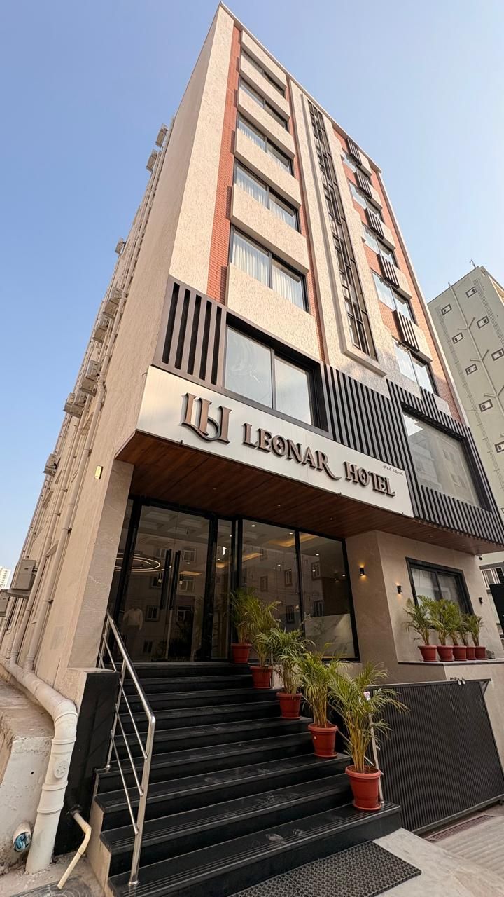 Entrada de hotel com uma placa indicando 'LEONAR HOTEL'.