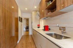 Um micro-ondas, uma máquina de lavar louça, uma cafeteira/bule 