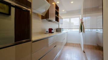 Um micro-ondas, uma máquina de lavar louça, uma cafeteira/bule