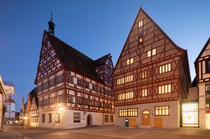 Um edifício tradicional em estilo de enxaimel, com telhado íngreme e um campanário.