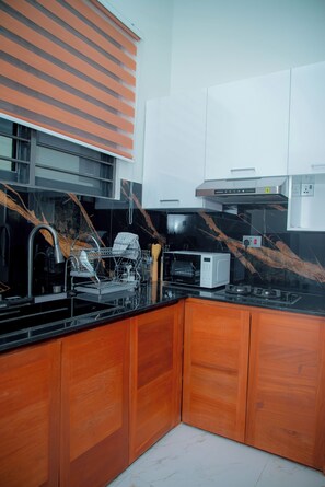 Quarto solteiro conforto, 1 cama King, cozinha, no piso térreo | Cozinha privada | Geladeira grande, micro-ondas, fogão, cooktop