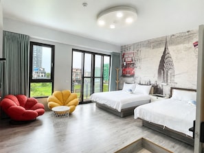 Quarto de hotel moderno com duas camas, uma cadeira vermelha, uma cadeira amarela e um mural com vista para a cidade.