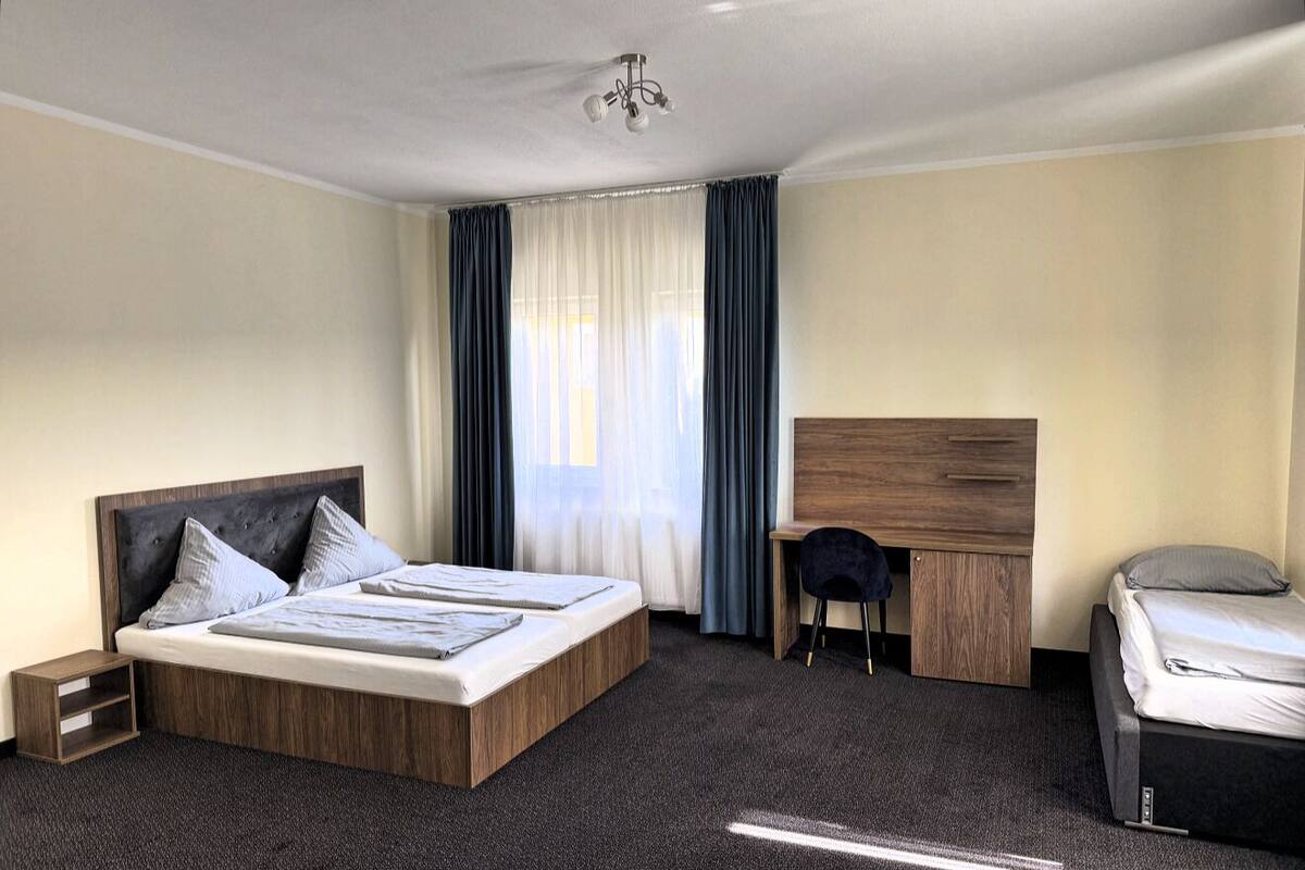 Quarto Triplo Deluxe, vista para o pátio | Secretária, secretária adequada para computadores portáteis