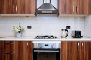 Apartamento, 2 quartos, varanda | Cozinha privada | Uma cafeteira/bule, utensílios de cozinha, Congelador, mesas de jantar