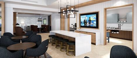 Um hall de hotel moderno com área de bar, espaços para sentar e uma tela de televisão.