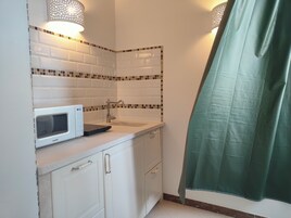 Frigobar, micro-ondas, cooktop, talheres/pratos/utensílios de cozinha