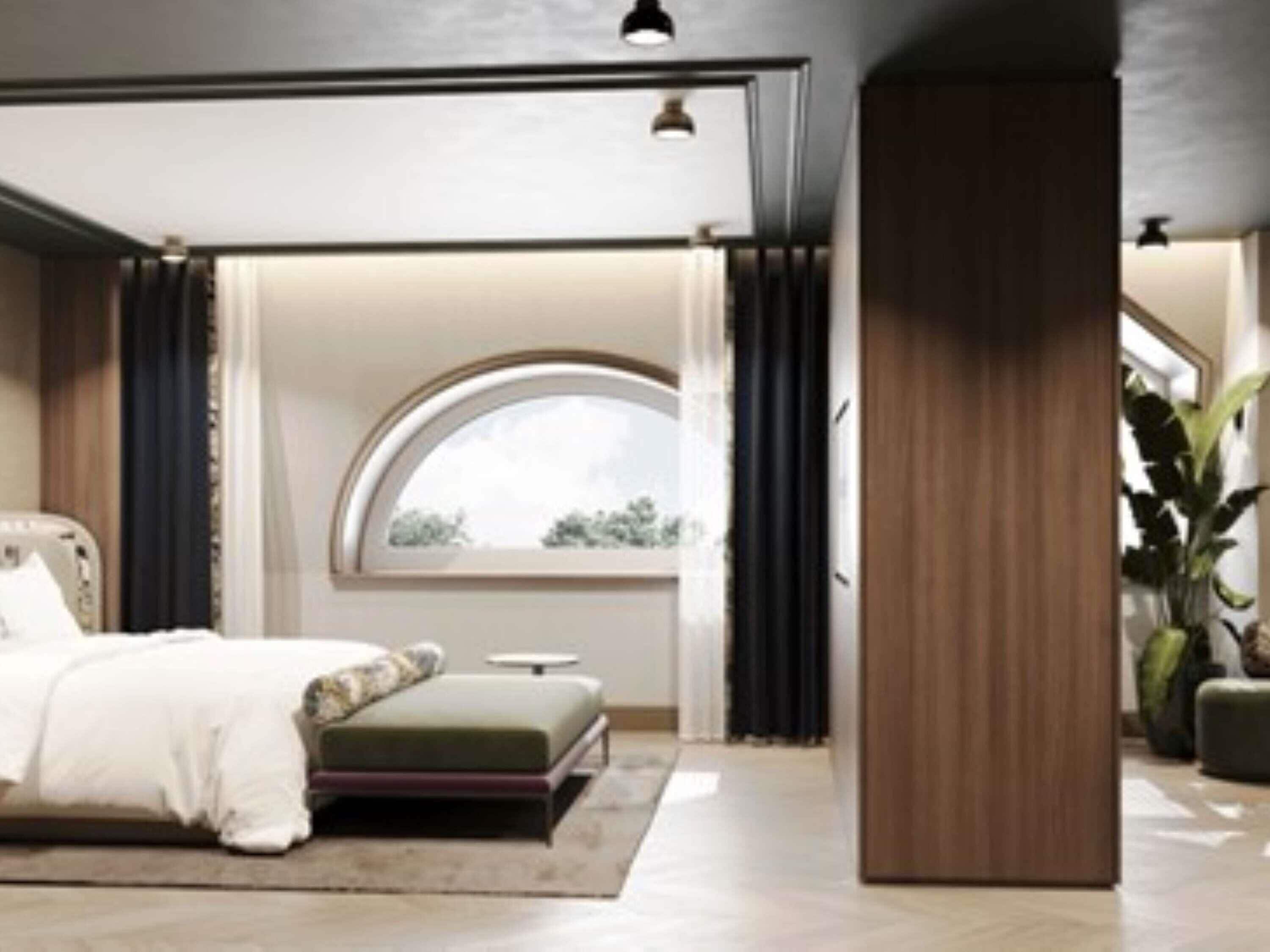 Quarto com cama, uma mesinha, janela com cortinas e uma planta.