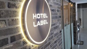 Placa de hotel com etiqueta circular e contorno luminoso.
