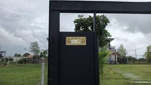 Uma entrada gradeada com uma placa mostrando o número 221.