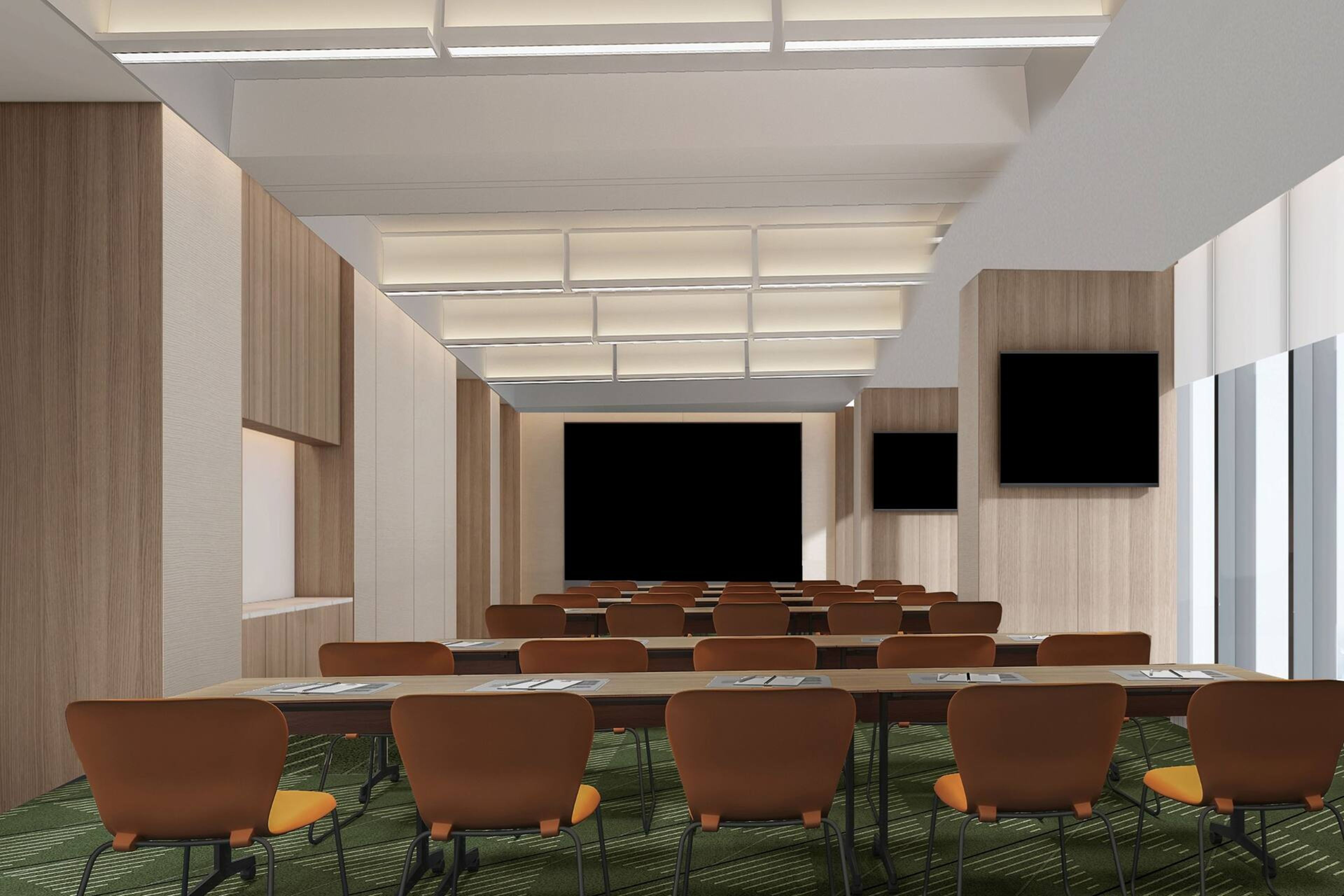 Uma sala de conferências com uma mesa comprida, várias cadeiras, um ecrã grande e uma televisão na parede.