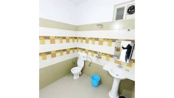 Quarto Duplo Deluxe | Casa de banho | Um polibã, um chuveiro fixo, chinelos, toalhas fornecidas