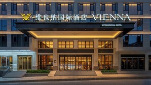 Hotel Vienna International com fachada moderna, grandes janelas de vidro e entrada imponente.