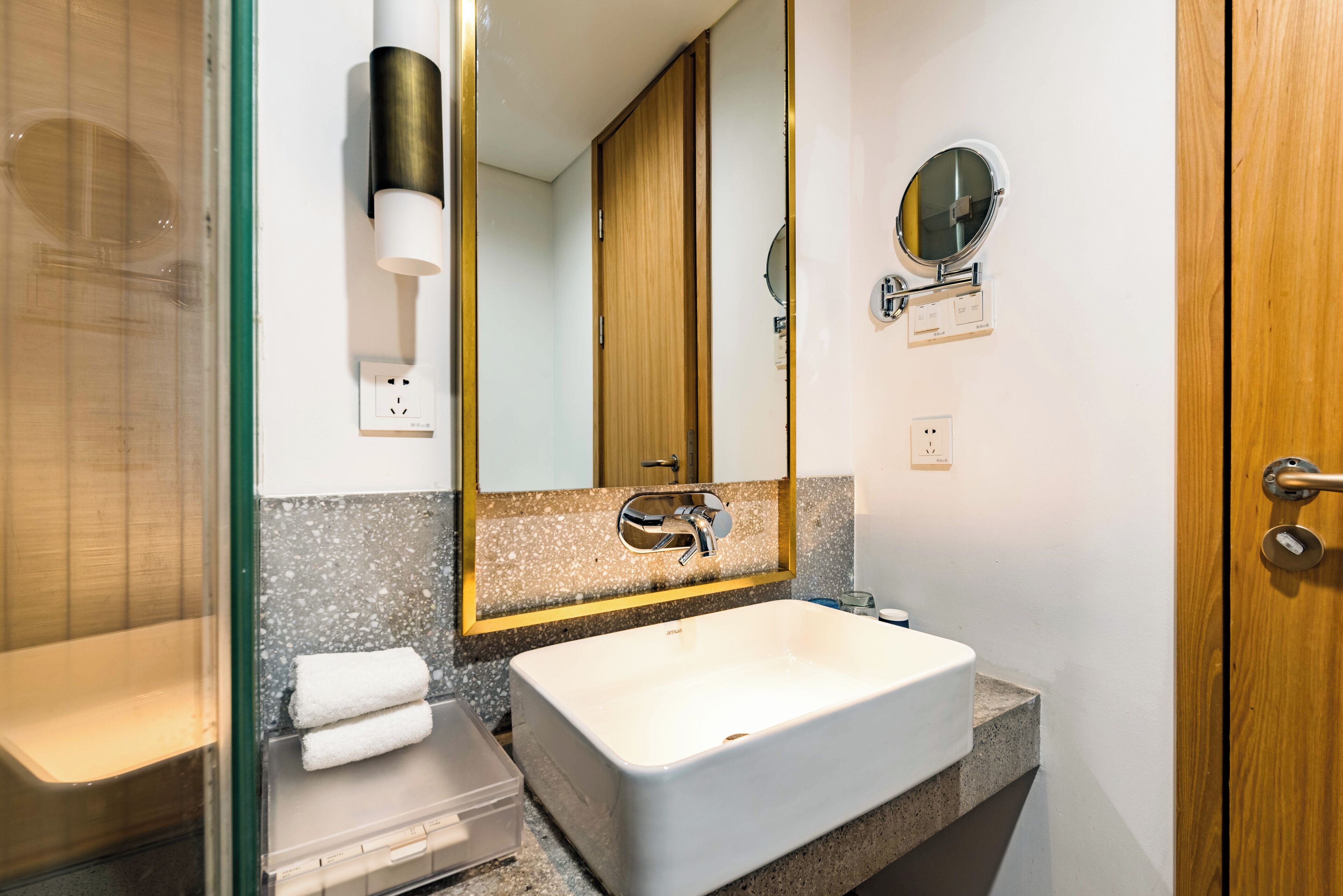 Uma casa de banho moderna com uma grande pia, um espelho e um porta-toalhas.