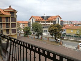 Um edifício residencial com um pátio central, várias varandas e uma mistura de estilos arquitetônicos modernos e tradicionais.