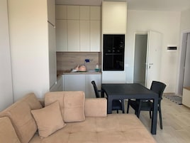Apartamento superior, vista para a cidade | Área de estar | TV