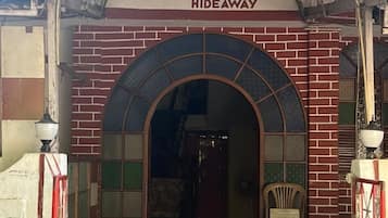 Entrada de hotel com uma placa indicando 'Hotel Pete's Hideaway'.