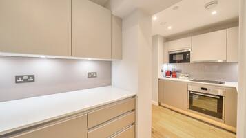 Apartamento, 2 quartos | Cozinha privada | Um frigorífico/congelador grande, um micro-ondas, um forno