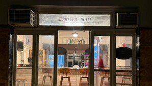Entrada do Hotel Jerilderie, com um aviso indicando que vende bebidas fermentadas e destiladas.
