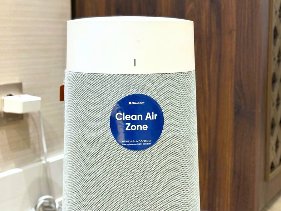 Um purificador de ar branco com um adesivo azul rotulado como