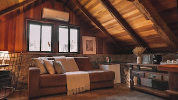 Suíte superior, vista para o jardim | Área de estar