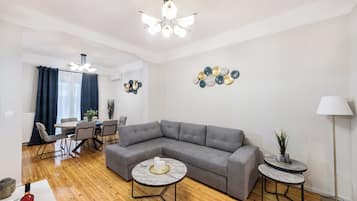 Apartamento, 3 quartos | Sala de estar | TV de ecrã plano