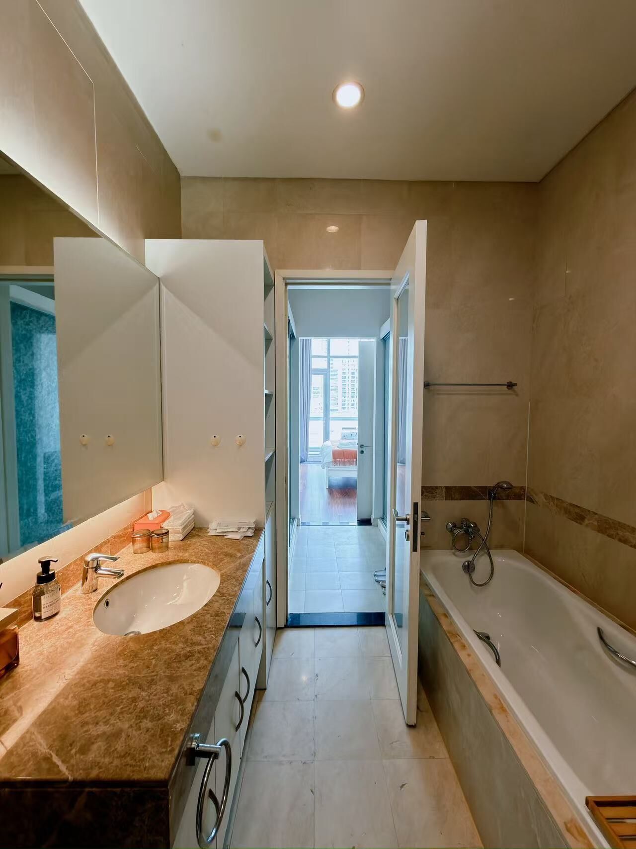 Uma casa de banho moderna com lavatório, espelho e banheira.