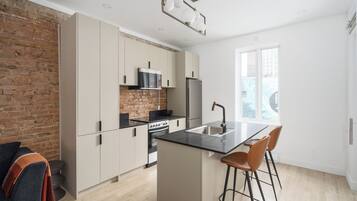 Um frigorífico/congelador grande, um micro-ondas, um forno